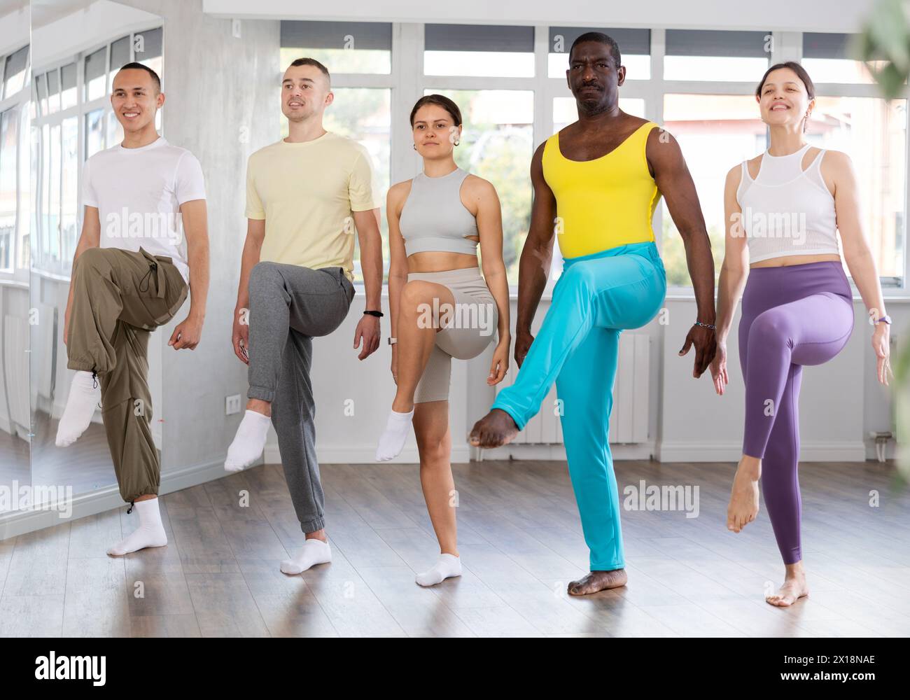 Group of motivated people mastering movements of folk Celtic dance ...