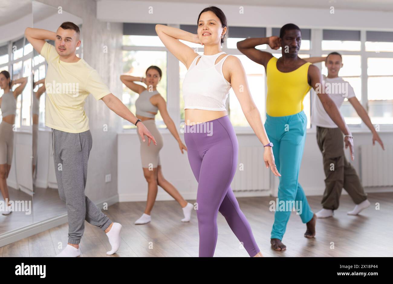 Group of multiethnic active people dancing social dance movements in ...