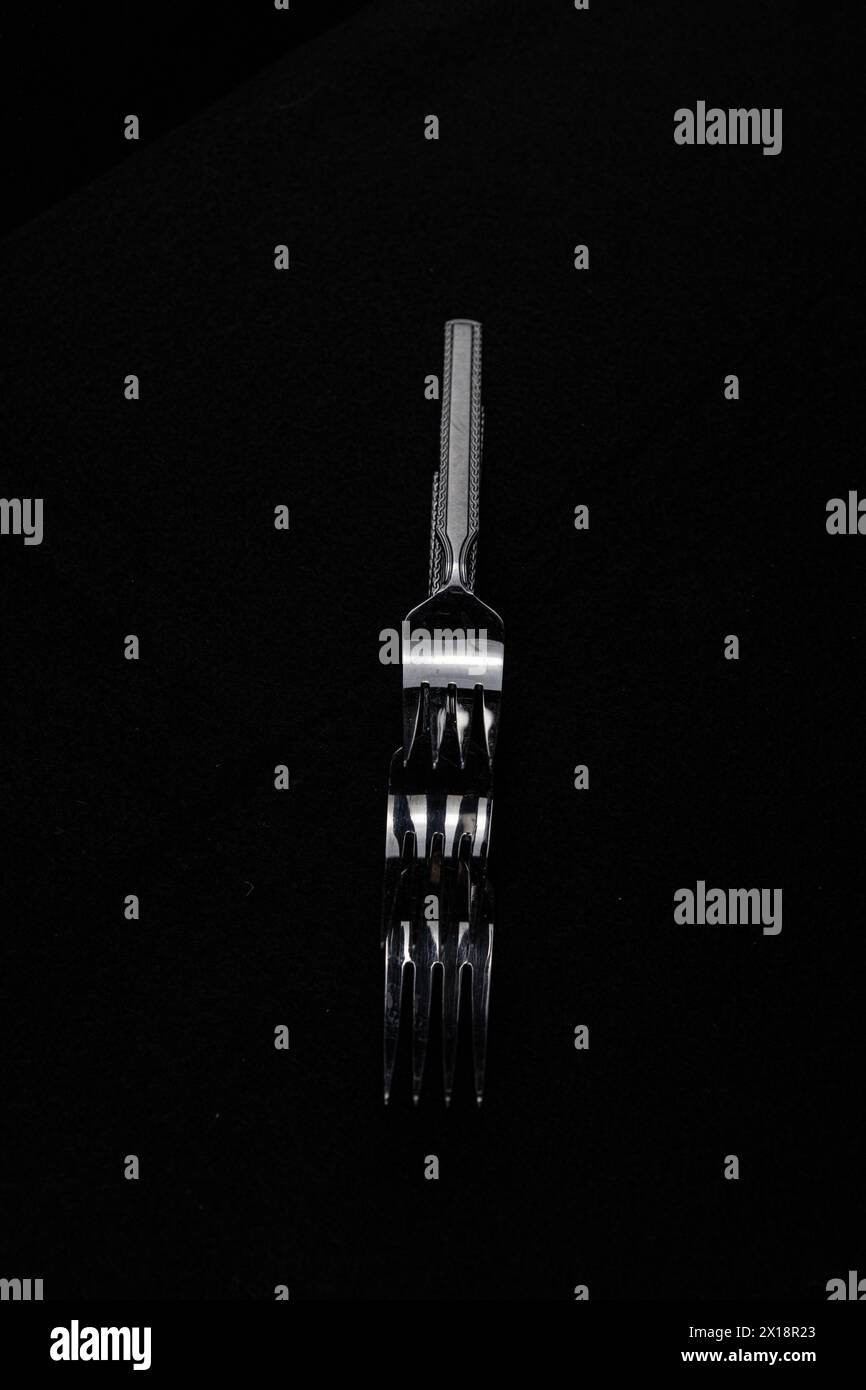 Three forks each one on top of the other, in black and white Stock ...