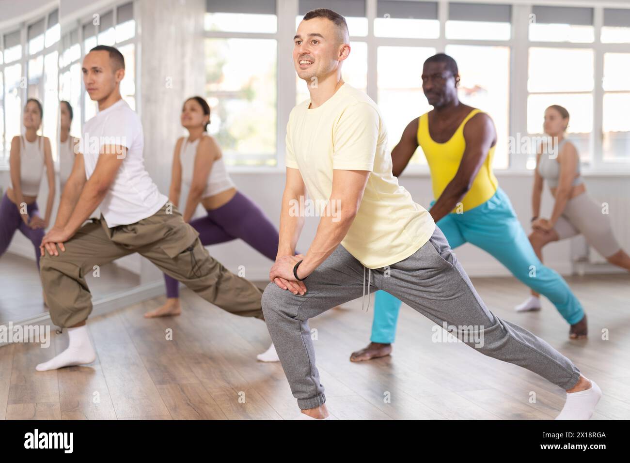 Group of people warming up before dance class Stock Photo - Alamy