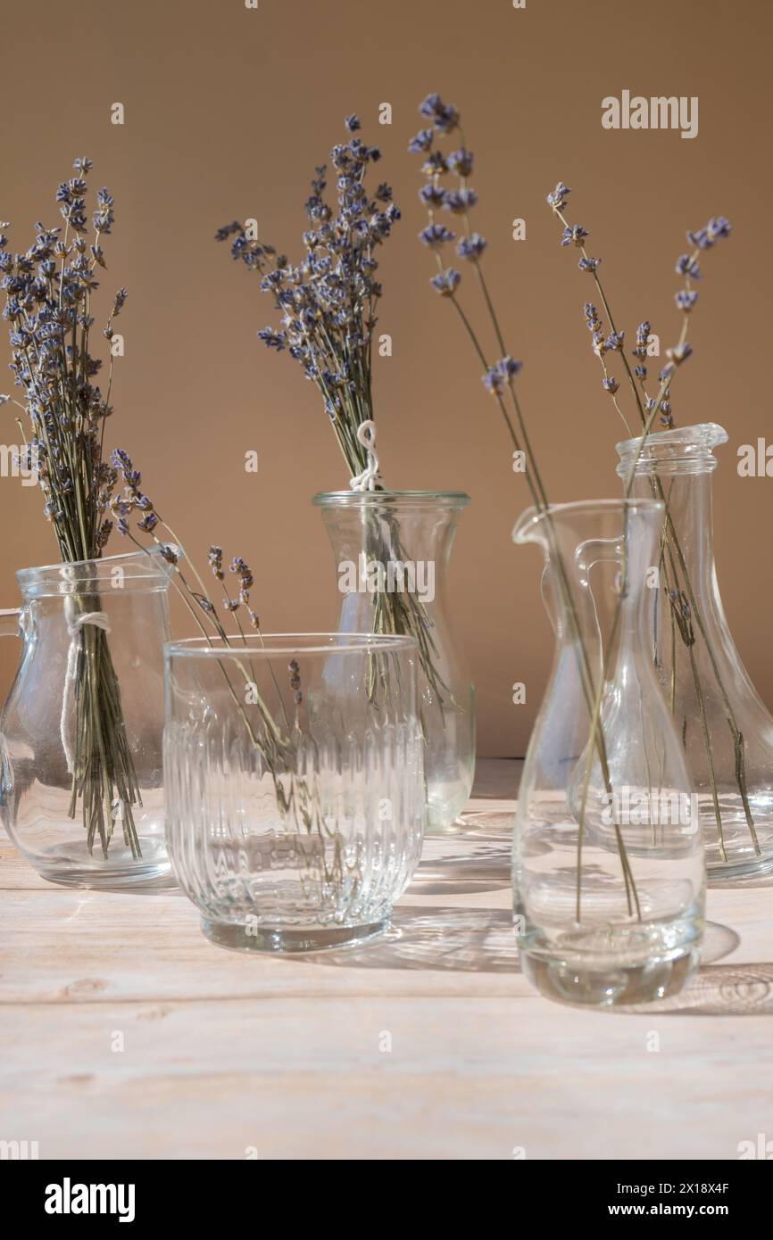 Lavender flowers in glass dishes. Dried herbal flowers on beige ...