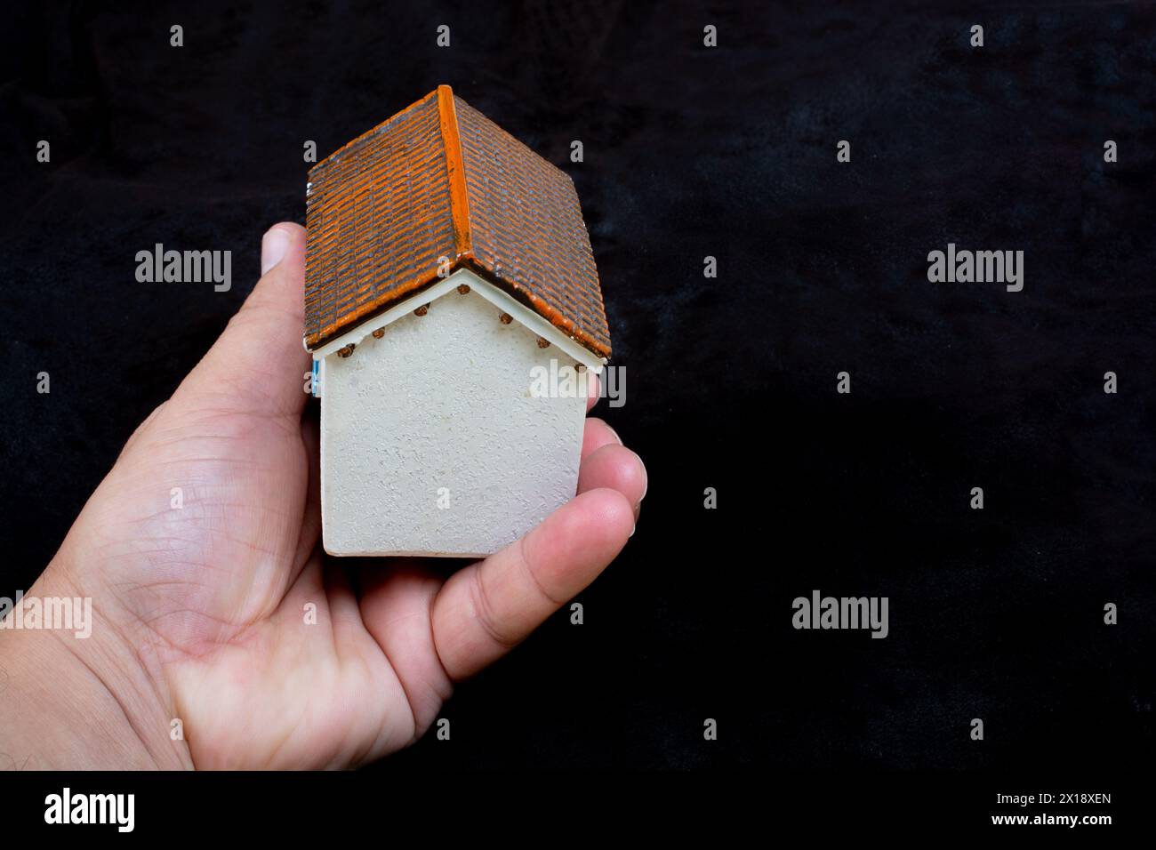 Little model house in hand as Invesment and Risk Management Stock Photo ...