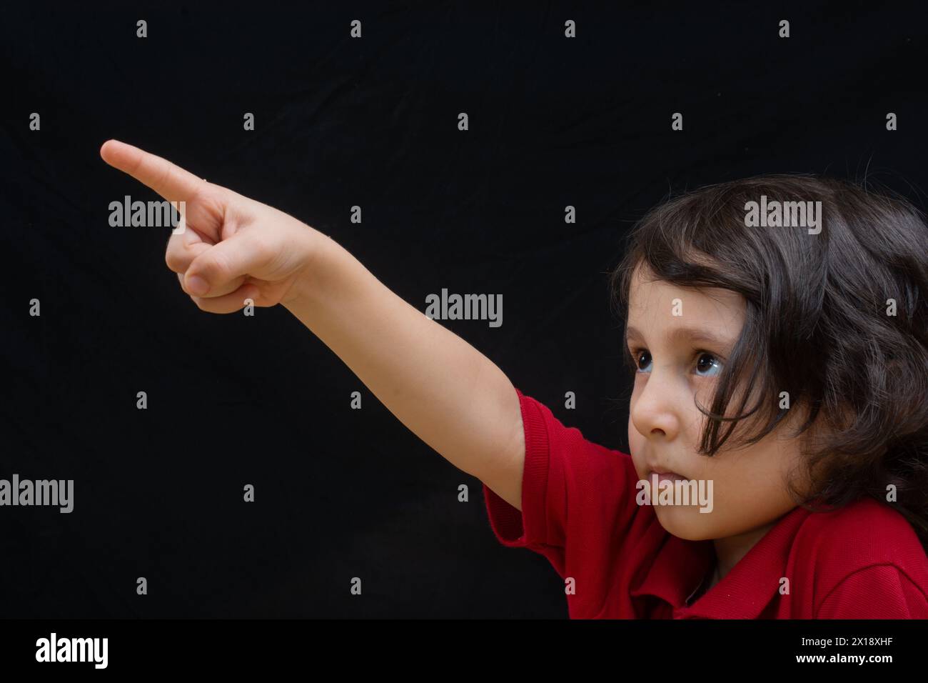 Happy smiling kid boy pointing his finger away Stock Photo - Alamy