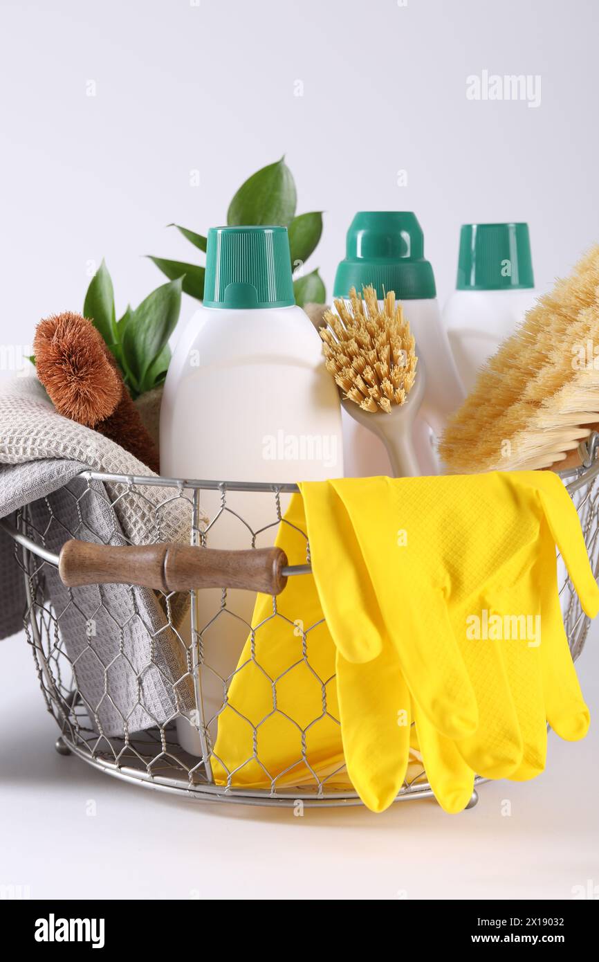 Set of different cleaning supplies in basket on white background Stock ...