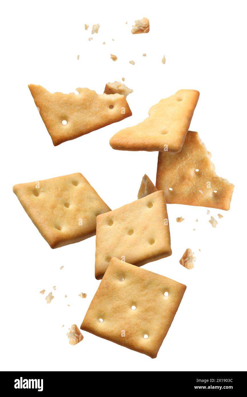 Tasty dry crackers falling on white background Stock Photo - Alamy