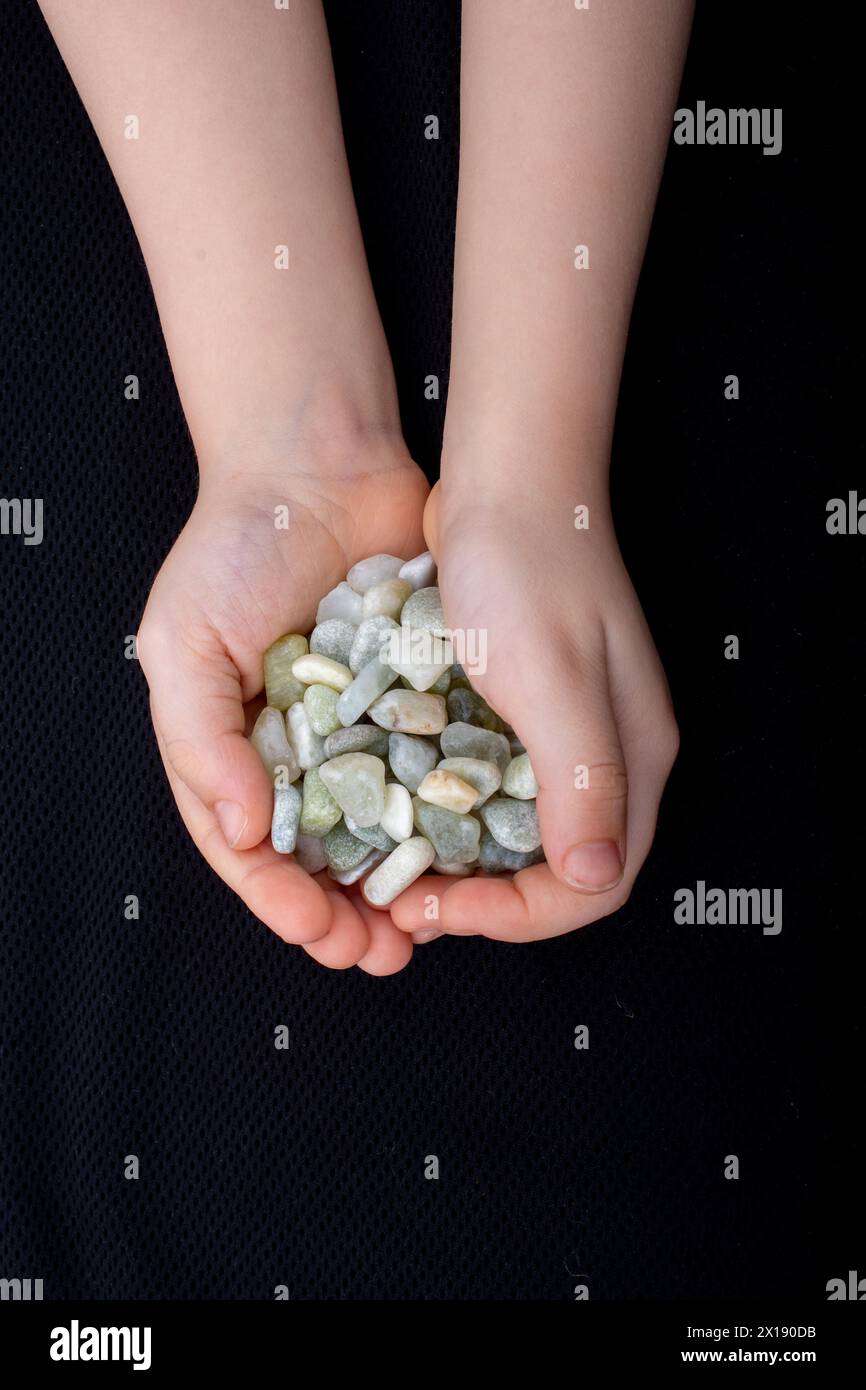 Handful of clean pebbles, gravels in hands Stock Photo - Alamy