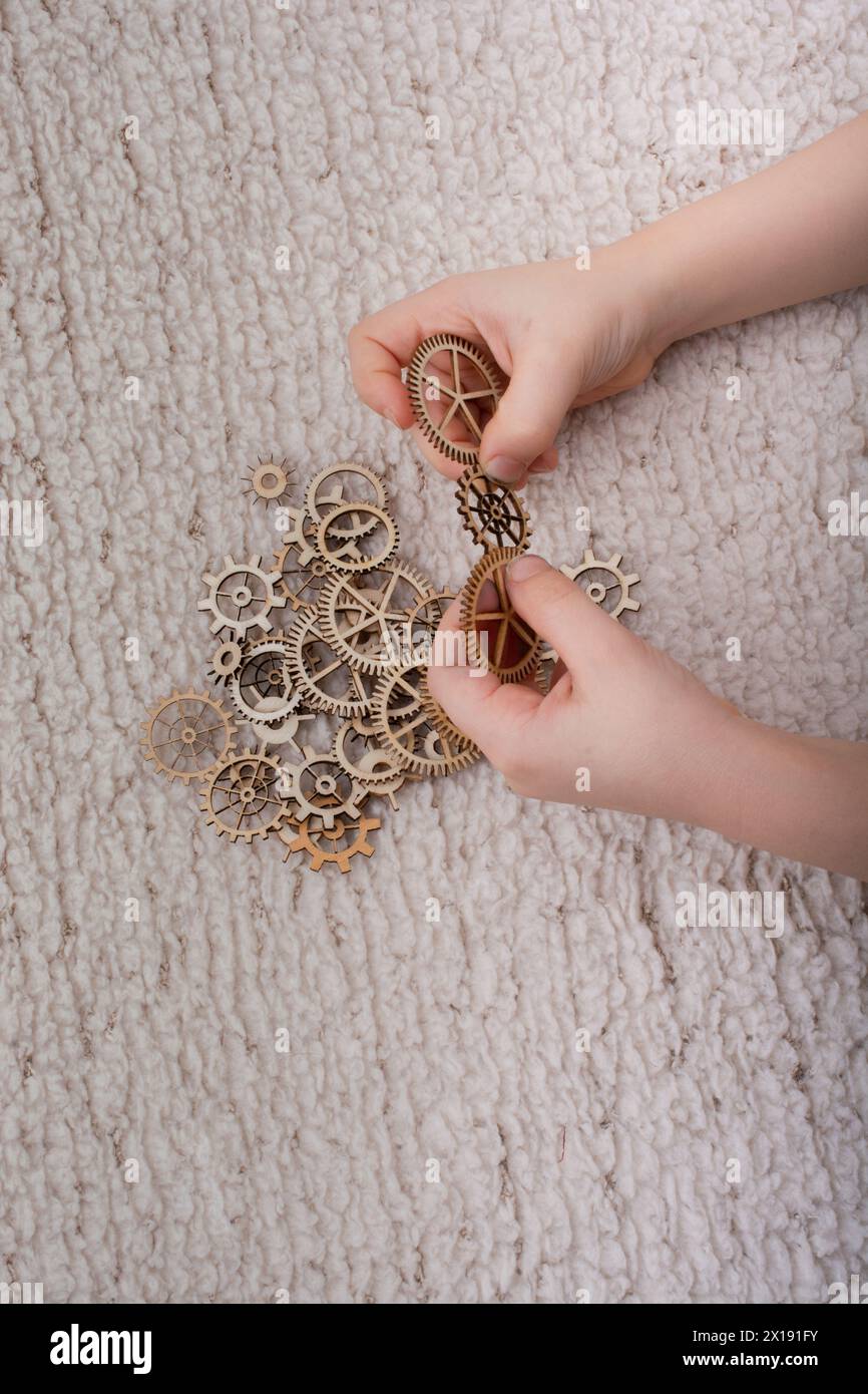 Hand holding gear wheels as the concept of mechanism Stock Photo - Alamy