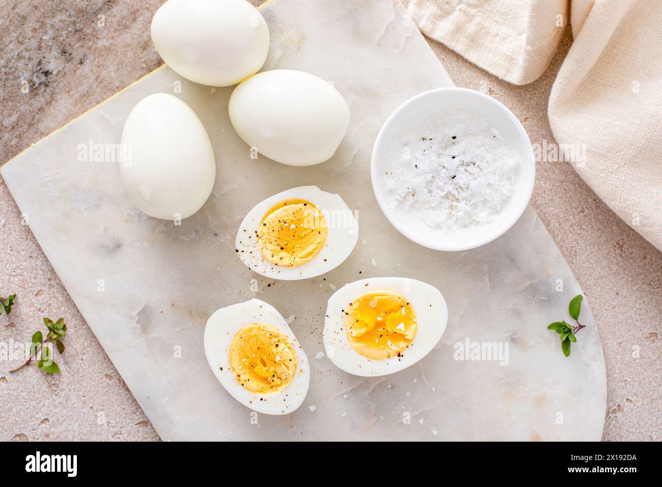 Hard boiled eggs peeled and cut in half with salt and pepper Stock ...