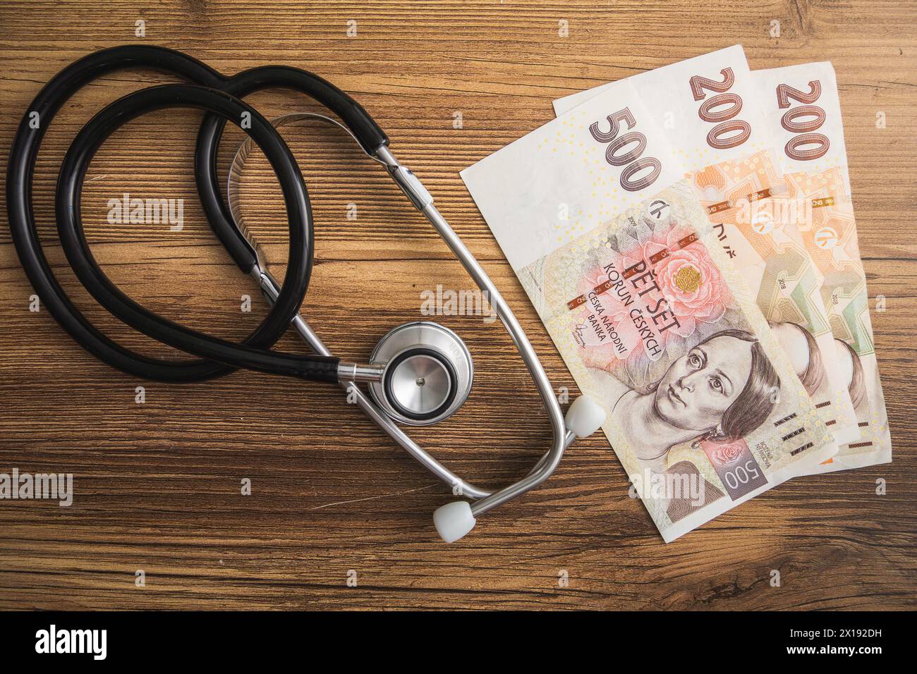 Stethoscope on Top of Pile of Czech crown banknotes, symbolizing ... Stethoscope on Top of Pile of Czech crown banknotes, symbolizing ...