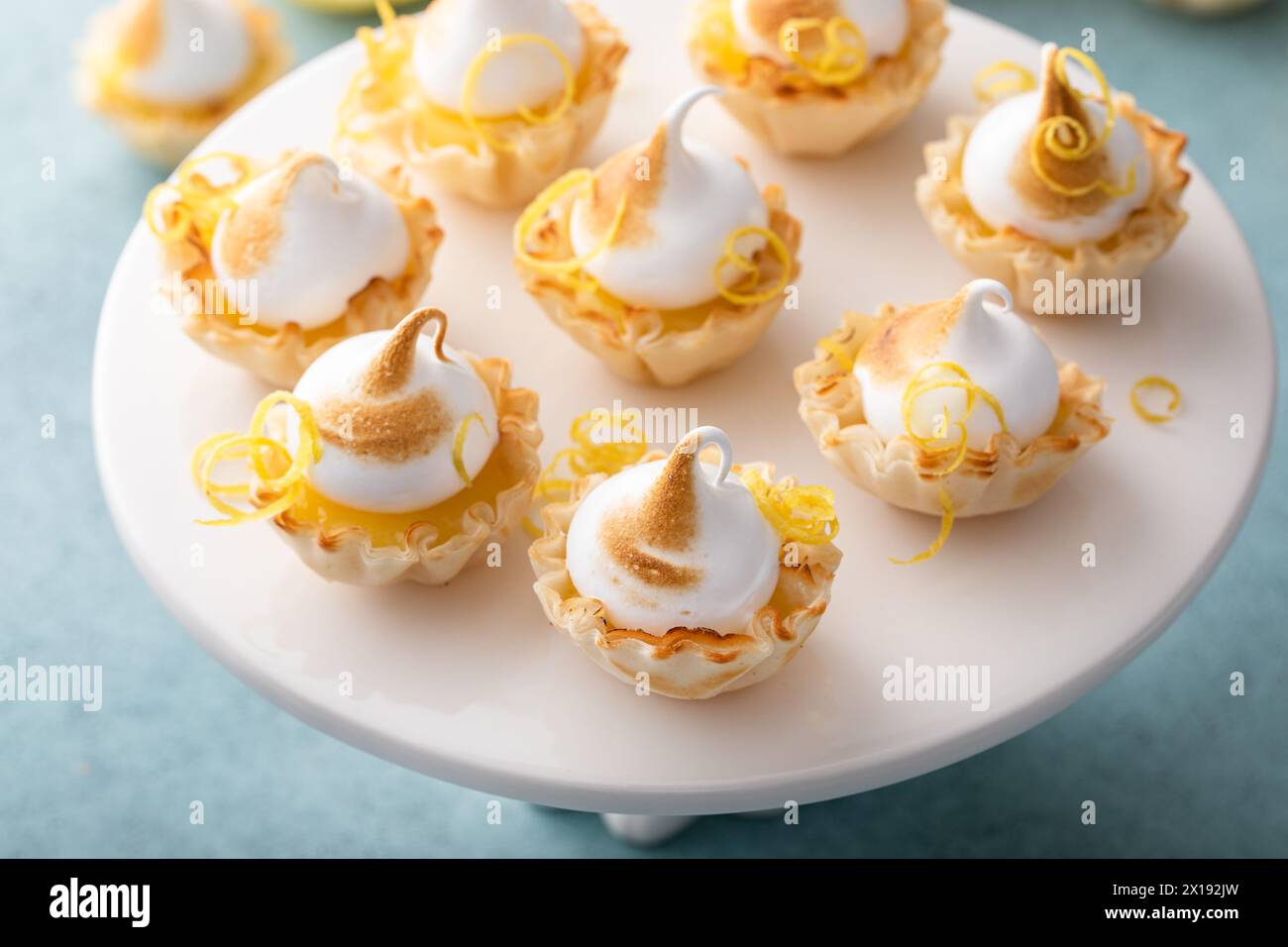 Lemon meringue tartlets with lemon curd in filo pastry shells Stock ...