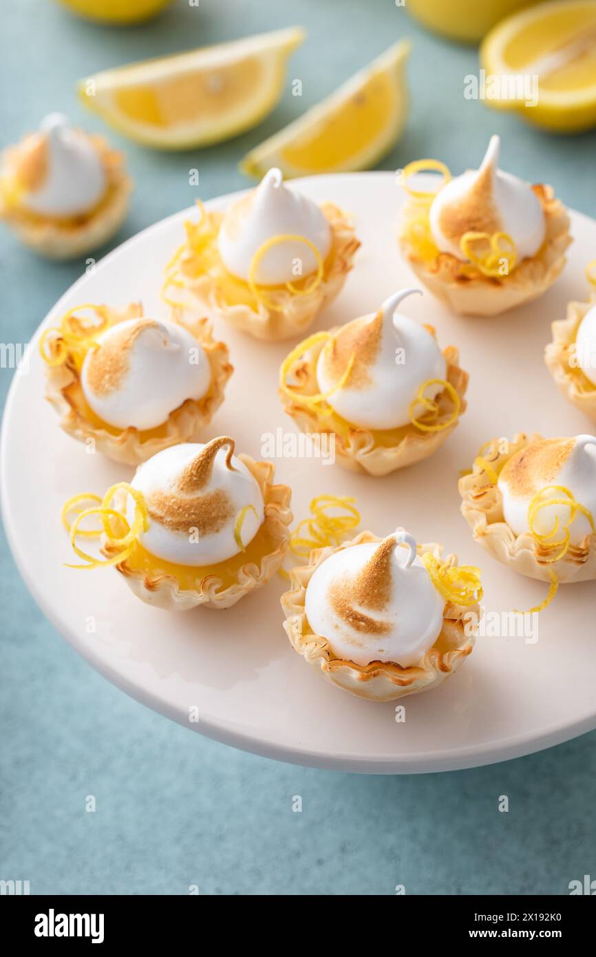 Lemon meringue tartlets with lemon curd in filo pastry shells Stock ...