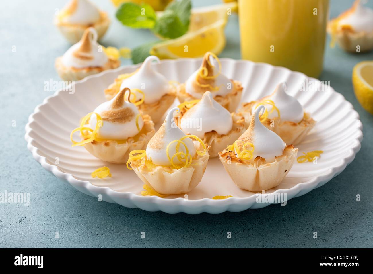 Lemon meringue tartlets with lemon curd in filo pastry shells Stock ...
