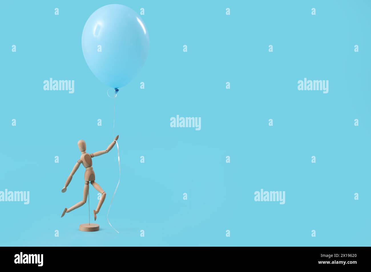 Wooden mannequin with balloon on blue background Stock Photo - Alamy
