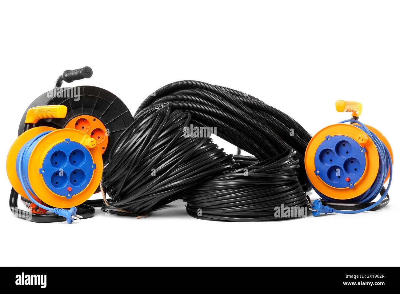 Rolled wires, flexible conduit tube and extension cable reels on white ...