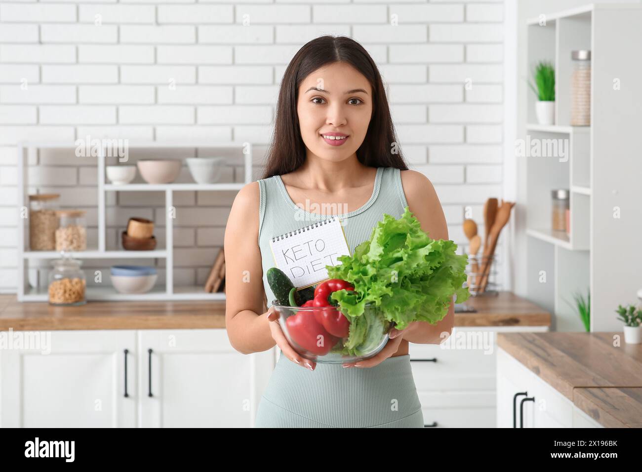 Beautiful young happy Asian woman holding notebook with nutrition ...