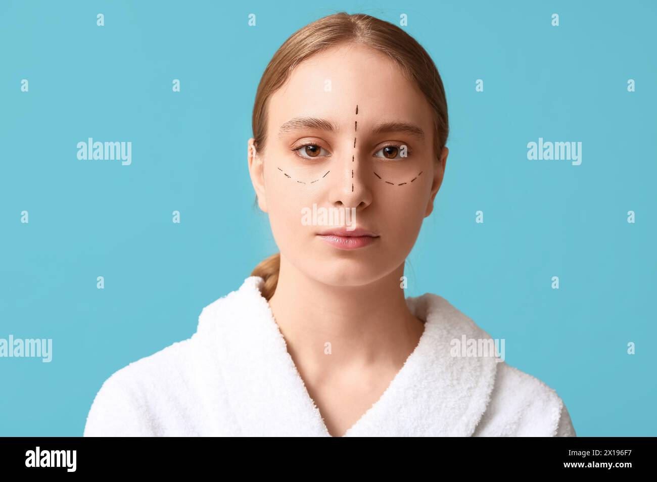 Young woman with marks on her face against blue background ...