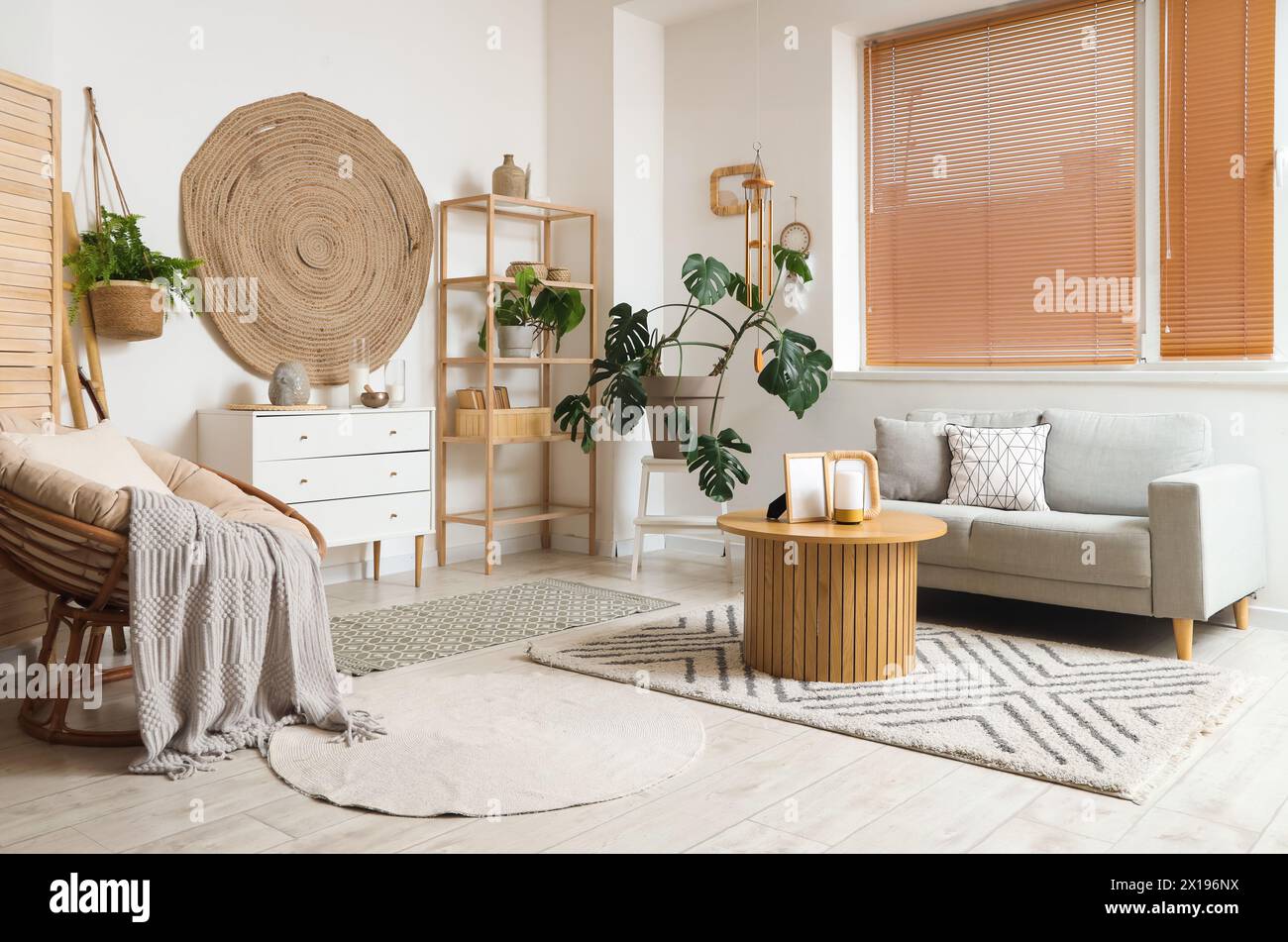 Interior of living room with wind chime, sofa and armchair Stock Photo ...