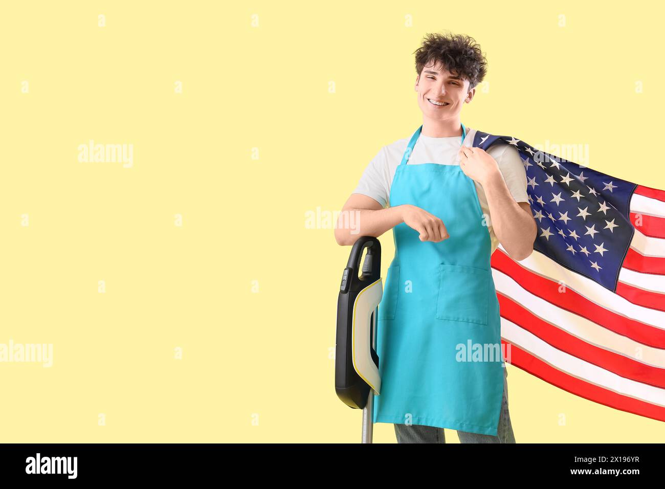 Male janitor with USA flag and vacuum cleaner on yellow background ...