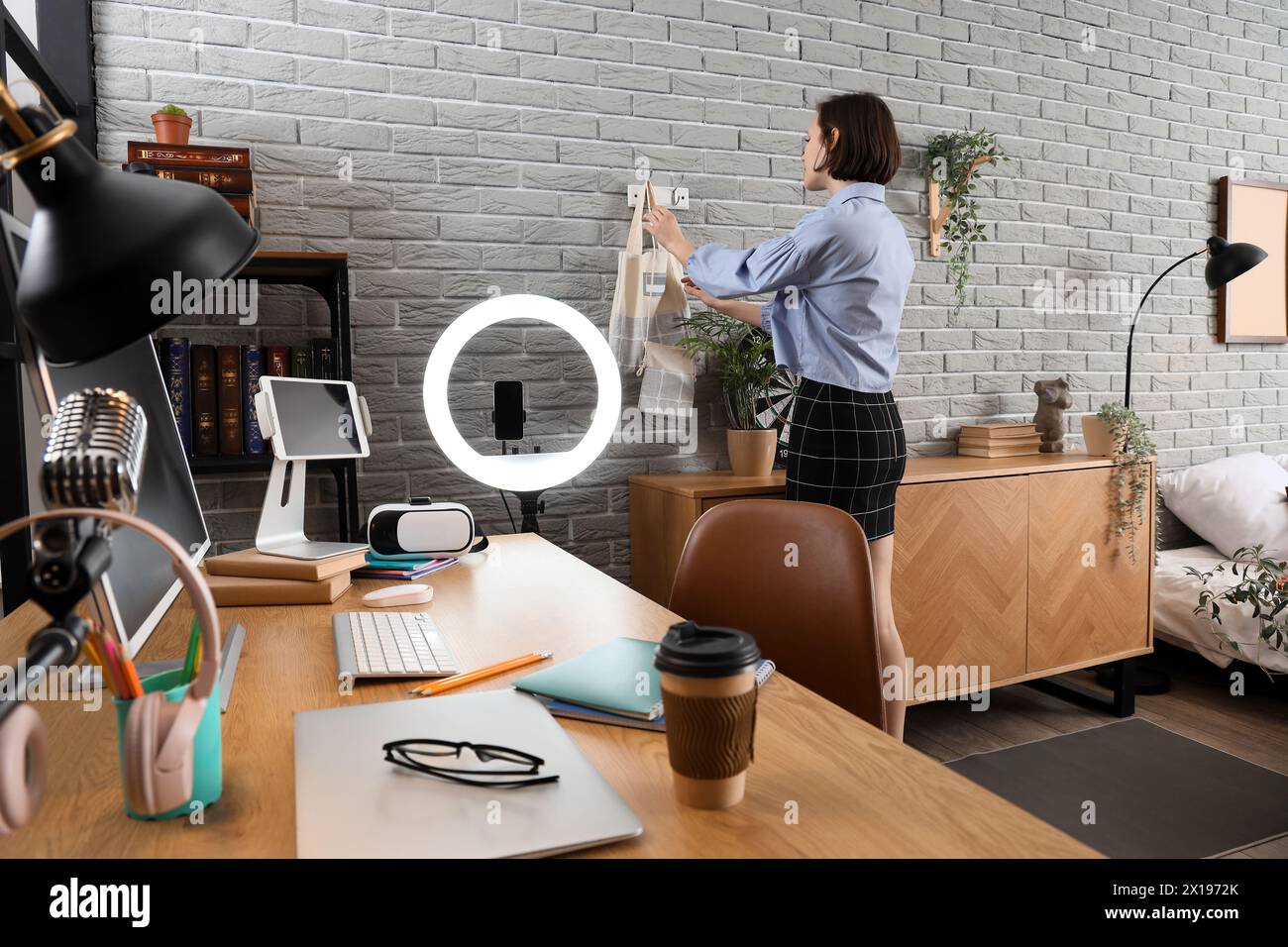 Female student taking bag from rack at home Stock Photo - Alamy