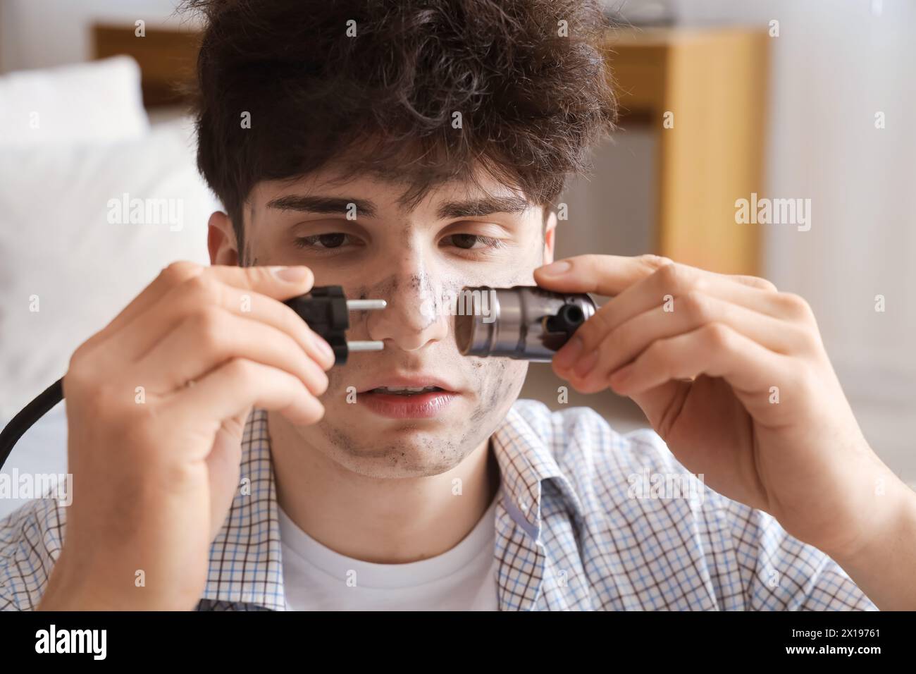 Electrocuted young man with burn face and plug at home, closeup Stock ...