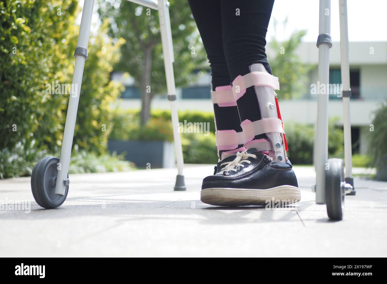 child with walking frame and knee orthosis outdoor Stock Photo - Alamy