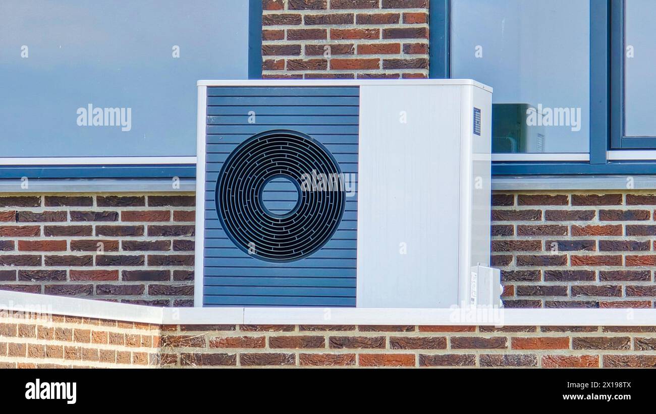 air source heat pump unit installed outdoors at a modern home in the ...