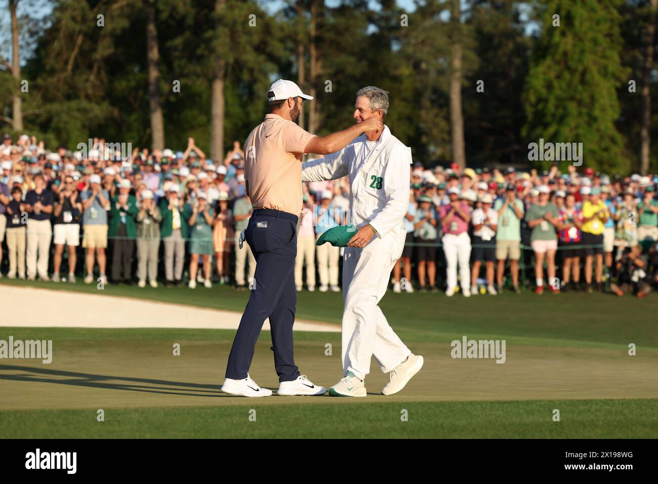 United States' Scottie Scheffler celebrates his win with his caddie Ted ...