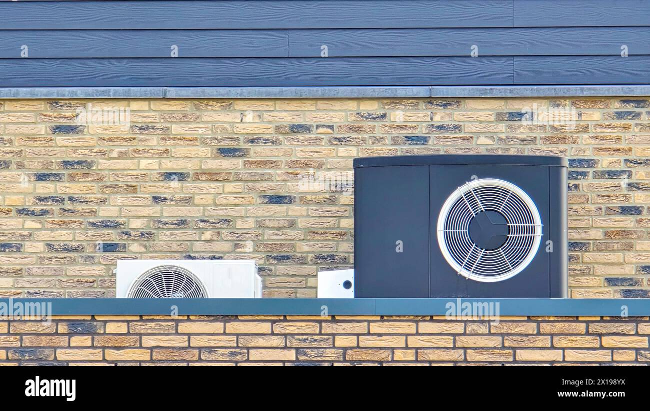 air source heat pump unit installed outdoors at a modern home with ...