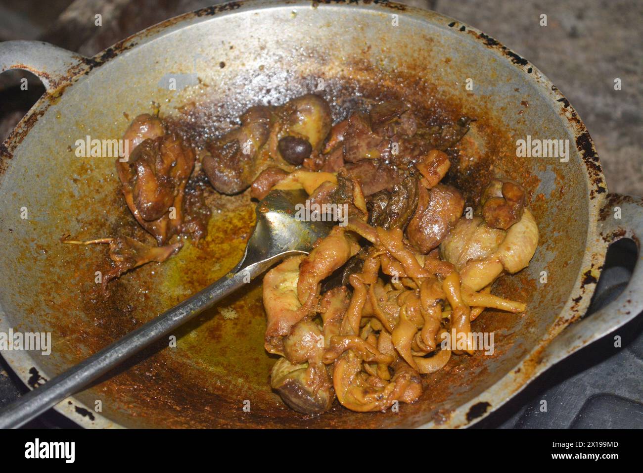 Photo of chicken being cooked on a cauldron Stock Photo - Alamy