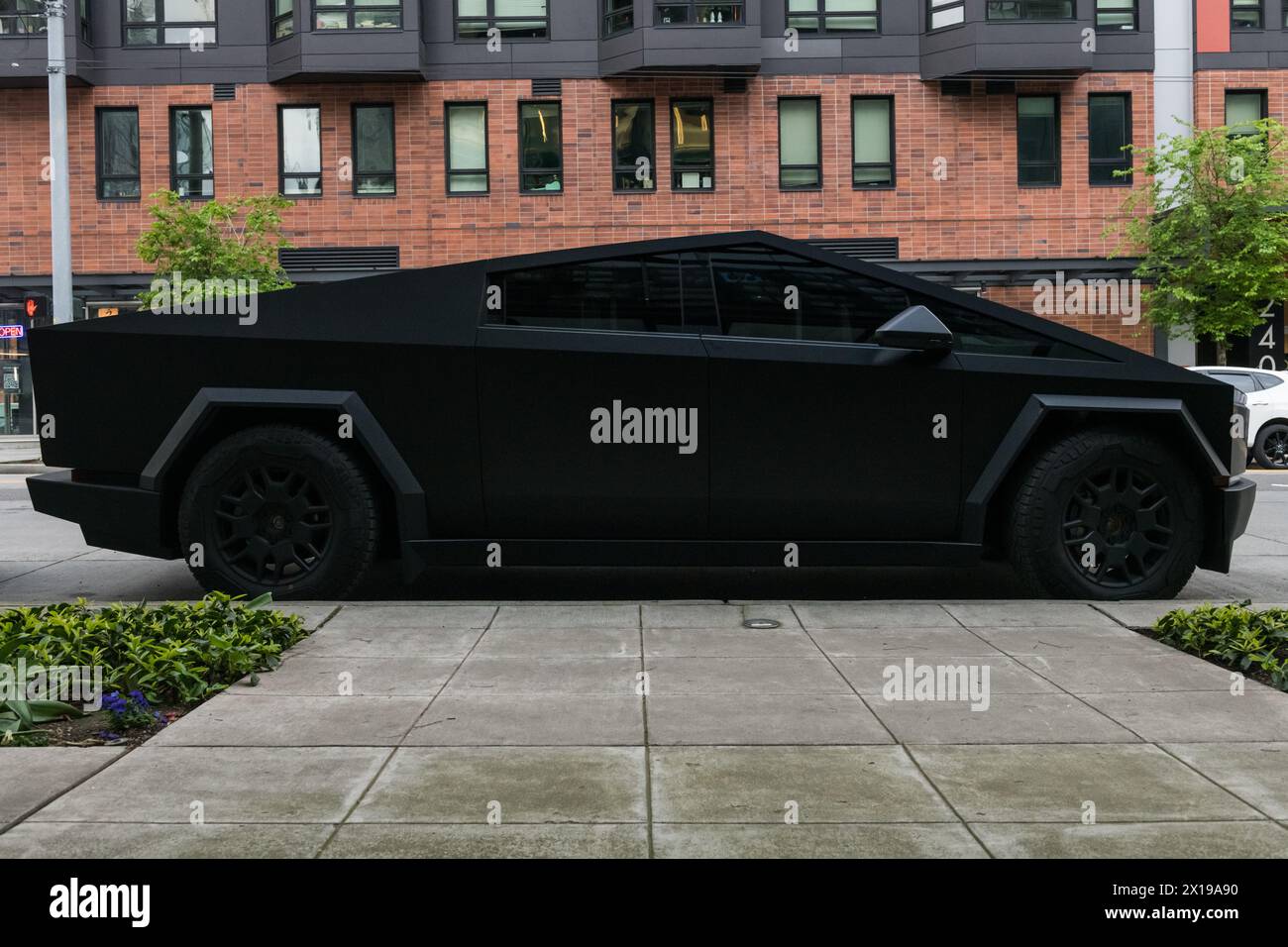 Seattle, USA. 15 Apr, 2024. A parked matte black wrapped Tesla ...