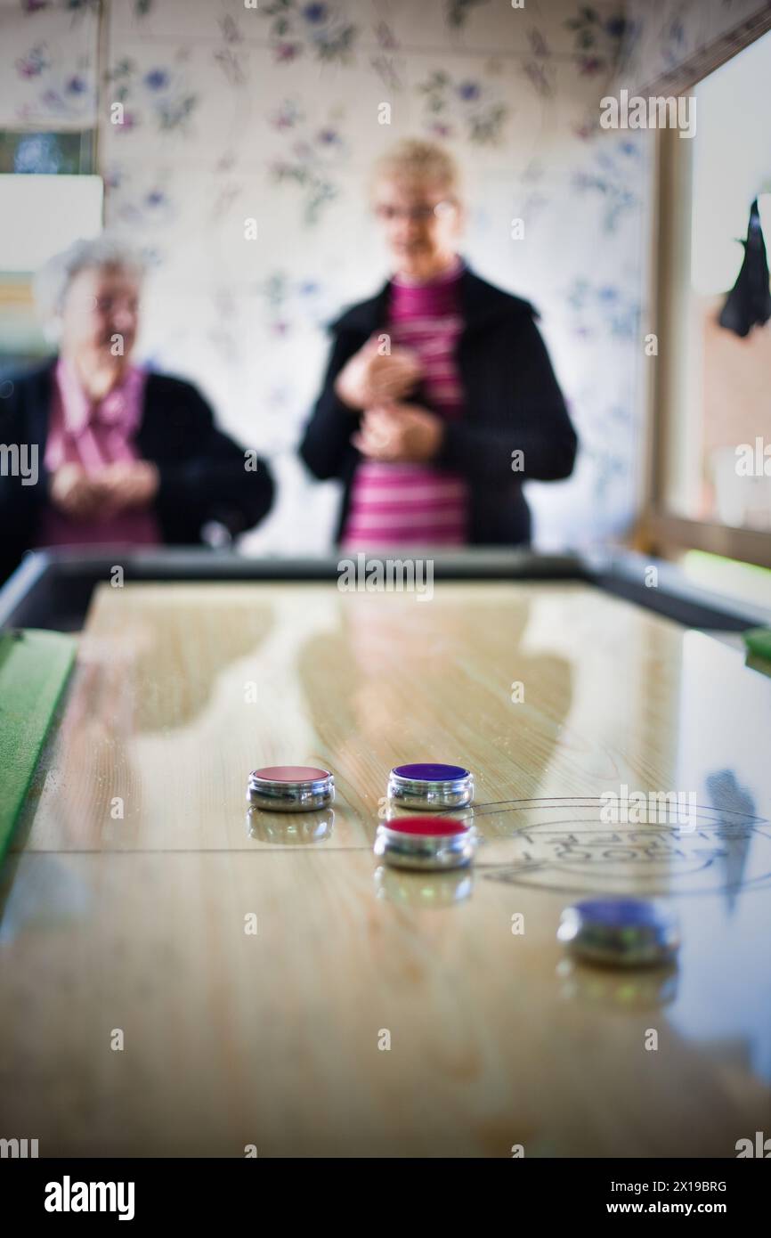 TWO ELDERLY RESIDENTS IN THE GAMES ROOM OF AN AGED CARE FACILITY ...