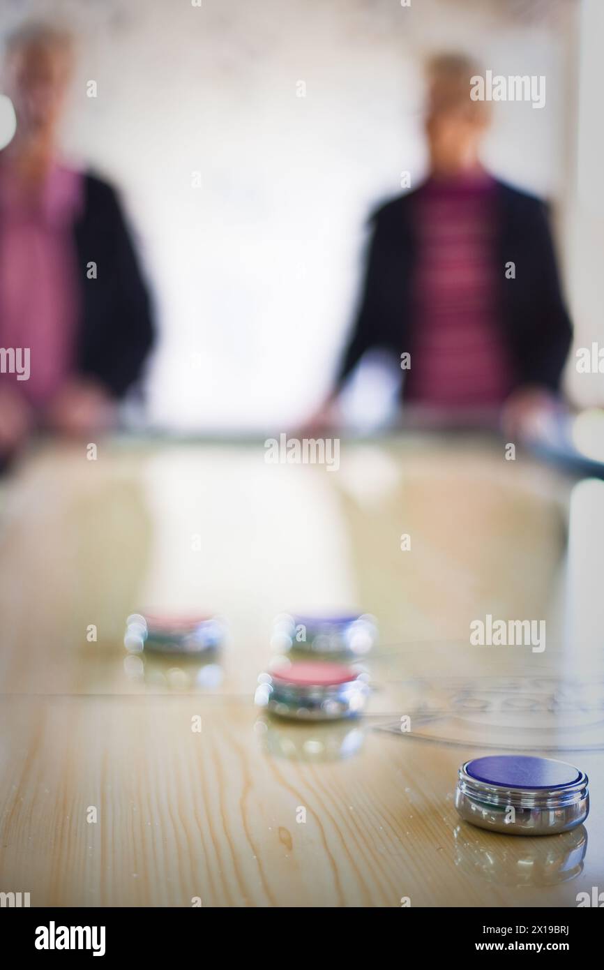 TWO ELDERLY RESIDENTS IN THE GAMES ROOM OF AN AGED CARE FACILITY ...