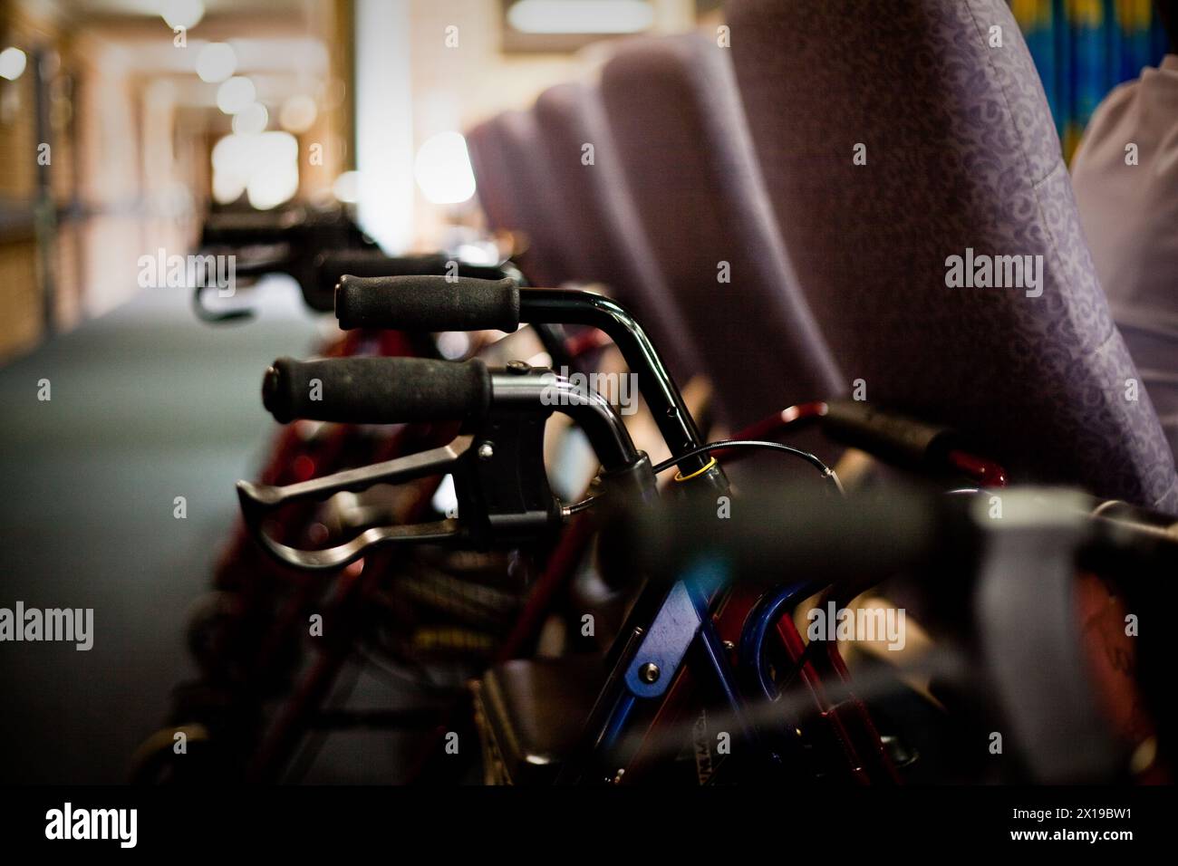 ROW OF MOBILITY WALKERS LINED UP IN AGED CARE FACILITY READY FOR USE ...