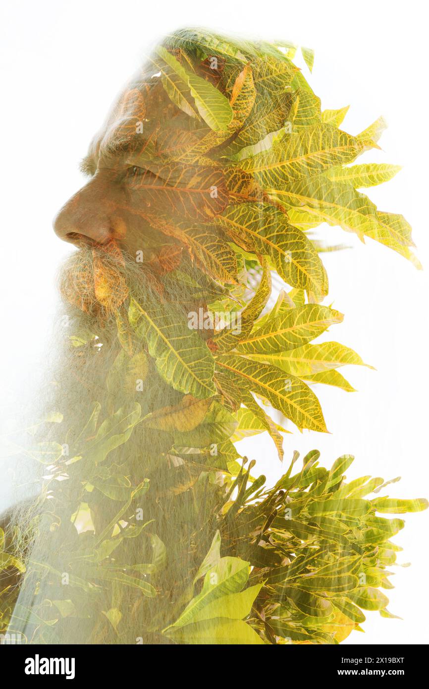 A creative double exposure profile portrait of an old man with a beard ...