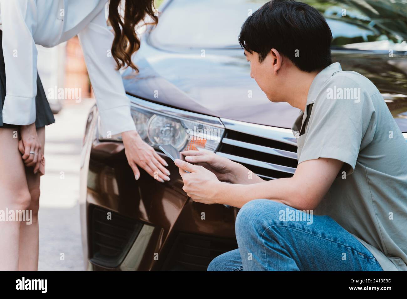 Car accident claim representative examining the accident with young ...