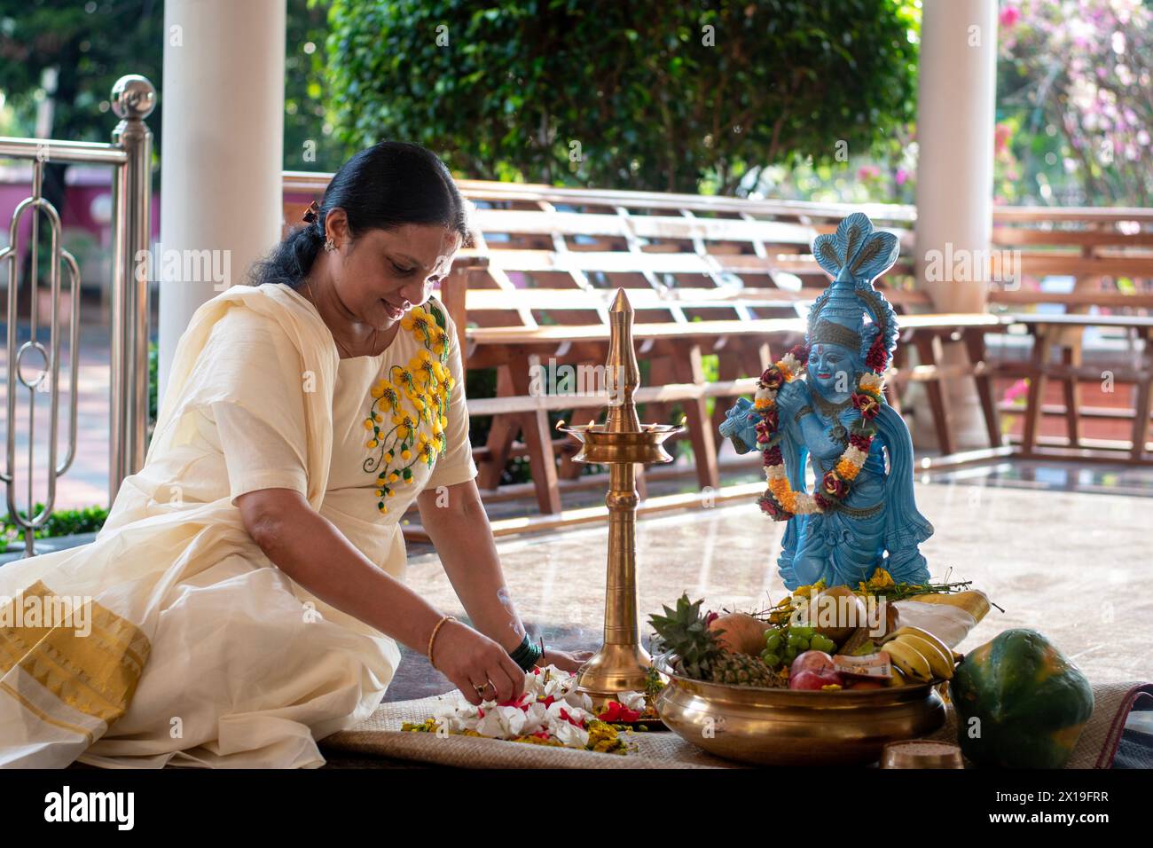 A Picture of middle aged malayali woman making Vishu kani Stock Photo - Alamy