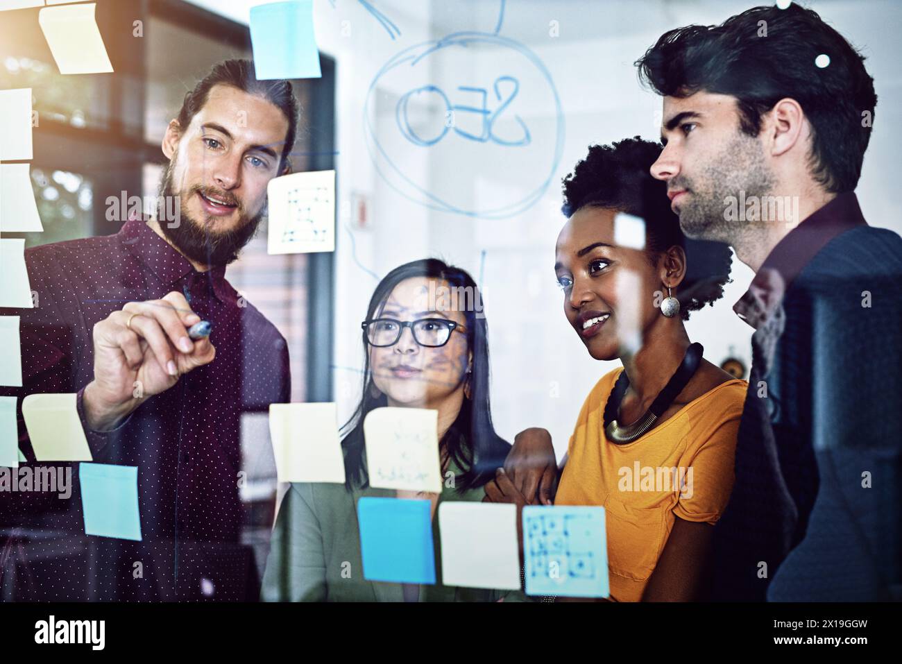 Collaboration, brainstorming and business people with glass board ...