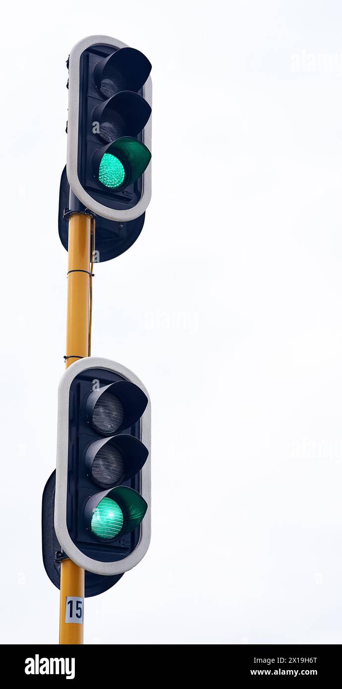 Traffic light, green and city intersection on street for go instruction ...
