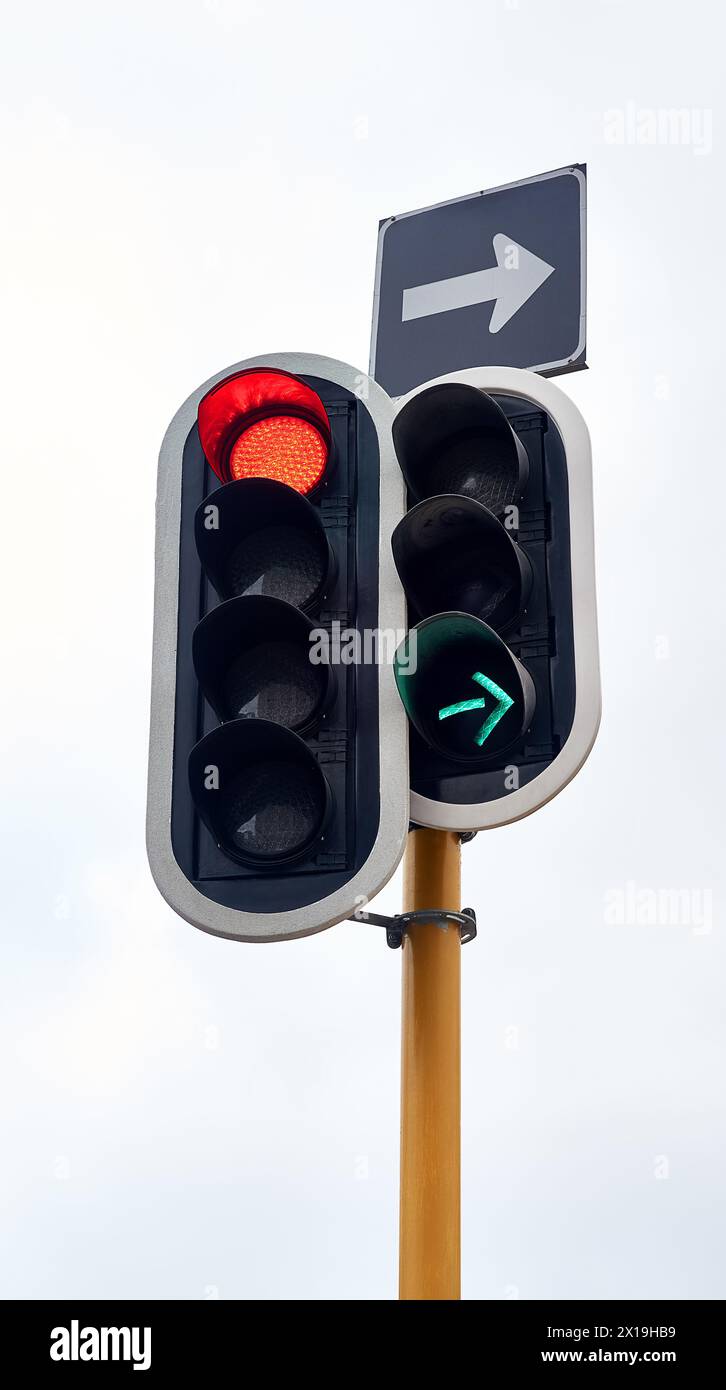 Traffic light, street and arrow with stop at intersection for ...