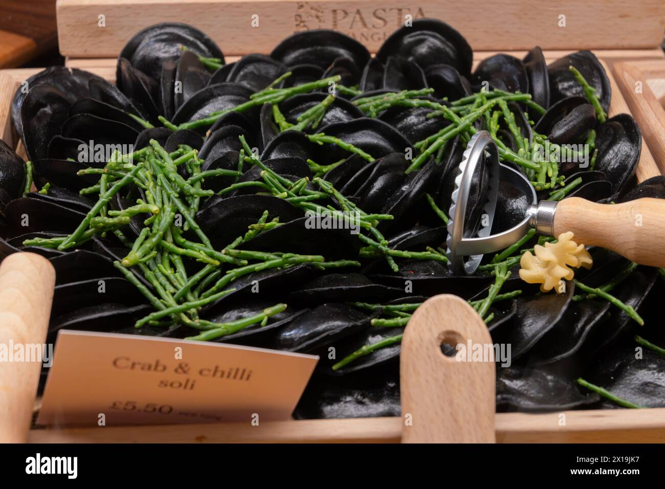 Italian food, fresh homemade black pasta with crab and chilli soli ...