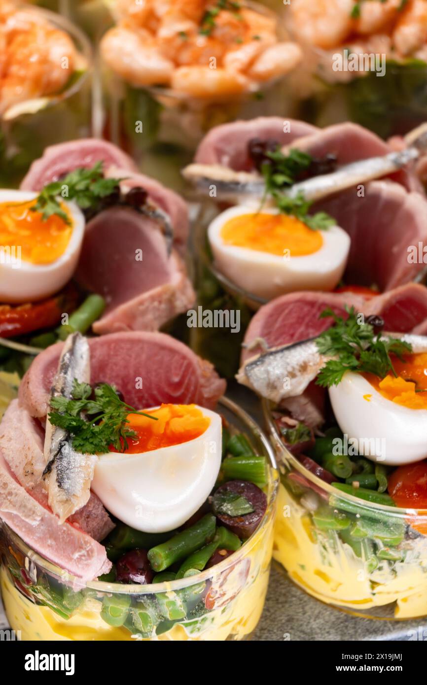 Fancy appetisers in glasses made with deafood, tuna fish, eggs ...