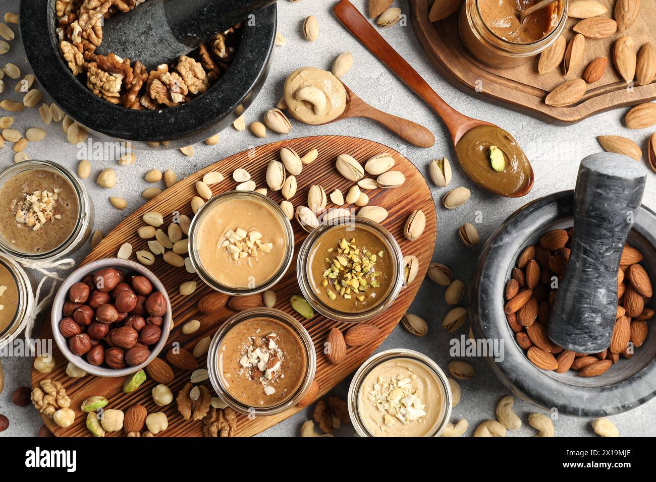 Making nut butters from different nuts. Flat lay composition on light ...