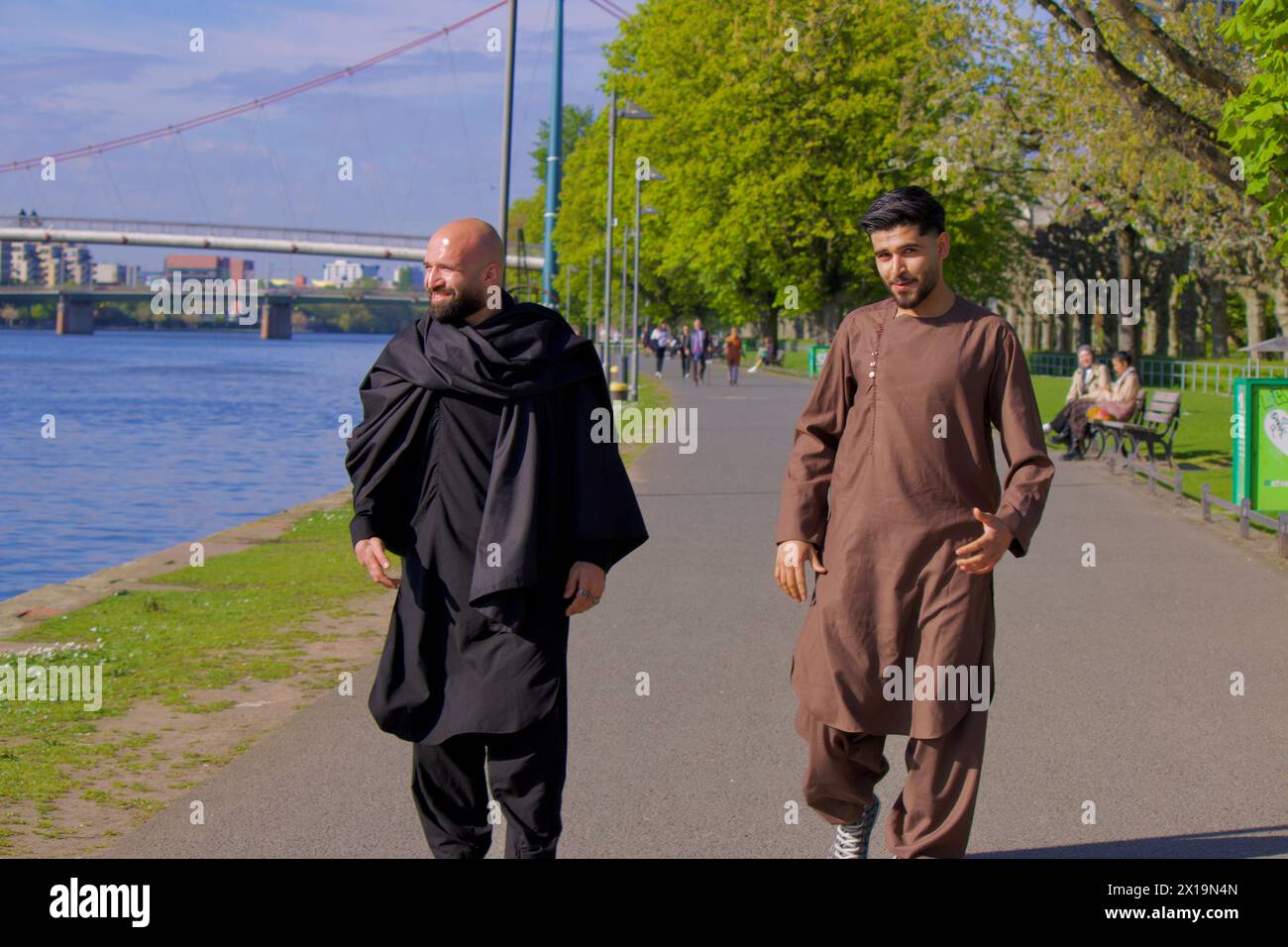 2024 two young afghani men walk past the river hi-res stock photography ...