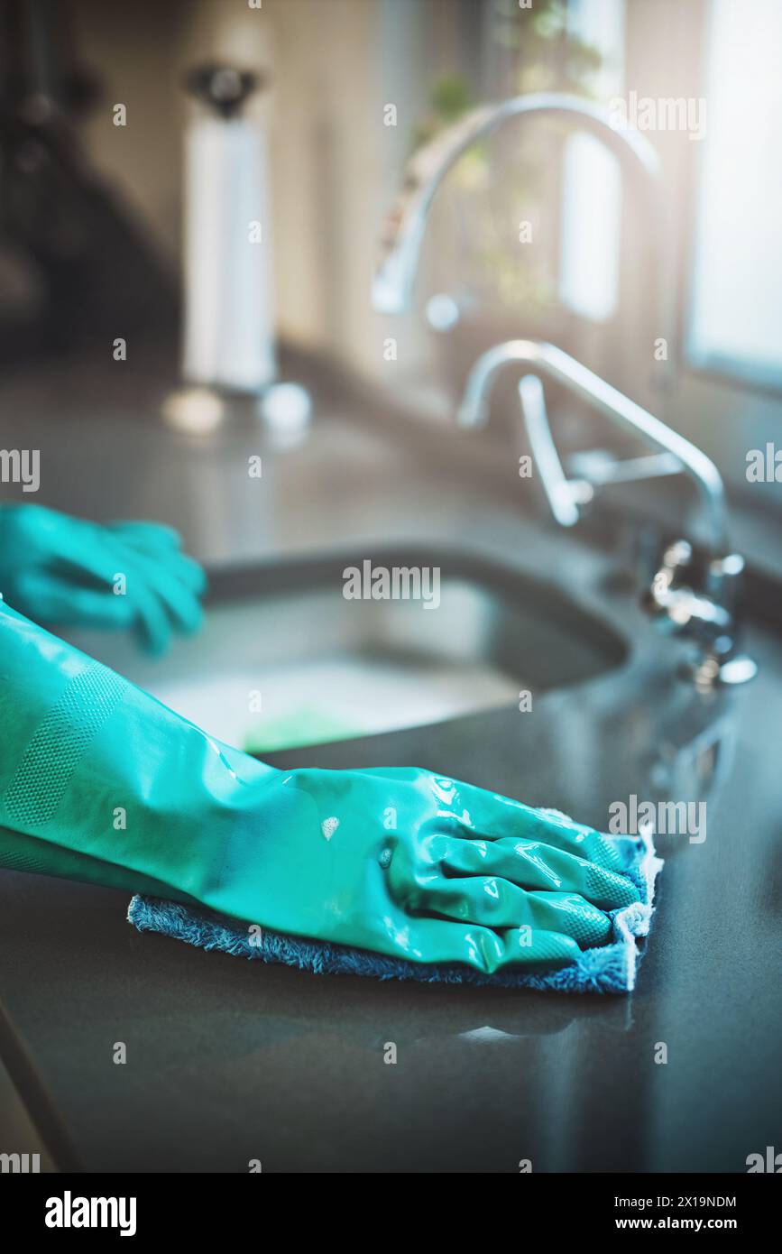 Hand, glove and kitchen with sink, cleaning and home routine for ...