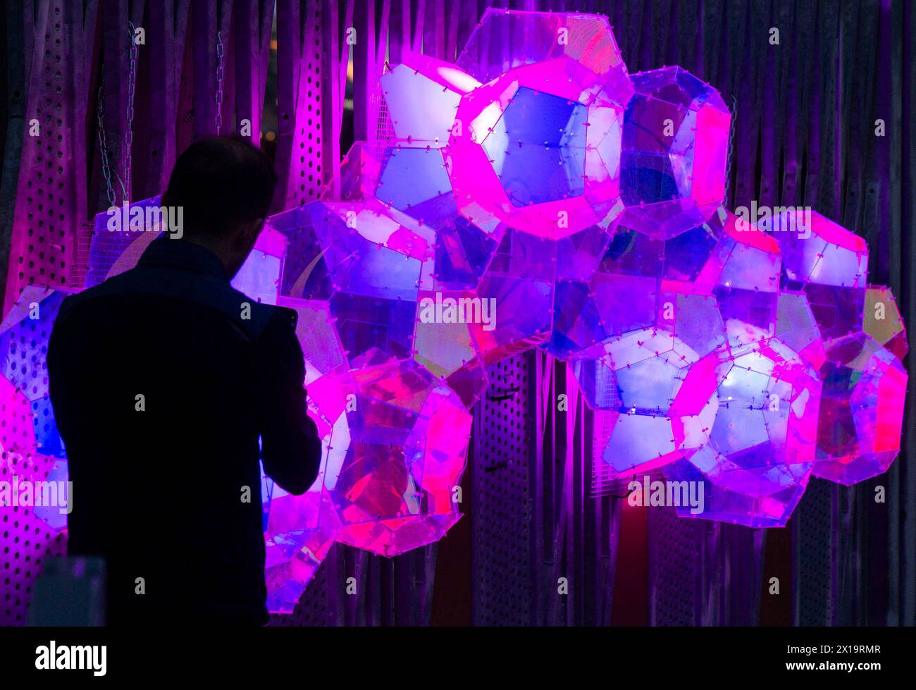 Toronto, Canada. 15th Apr, 2024. A man takes photos of a light art ...