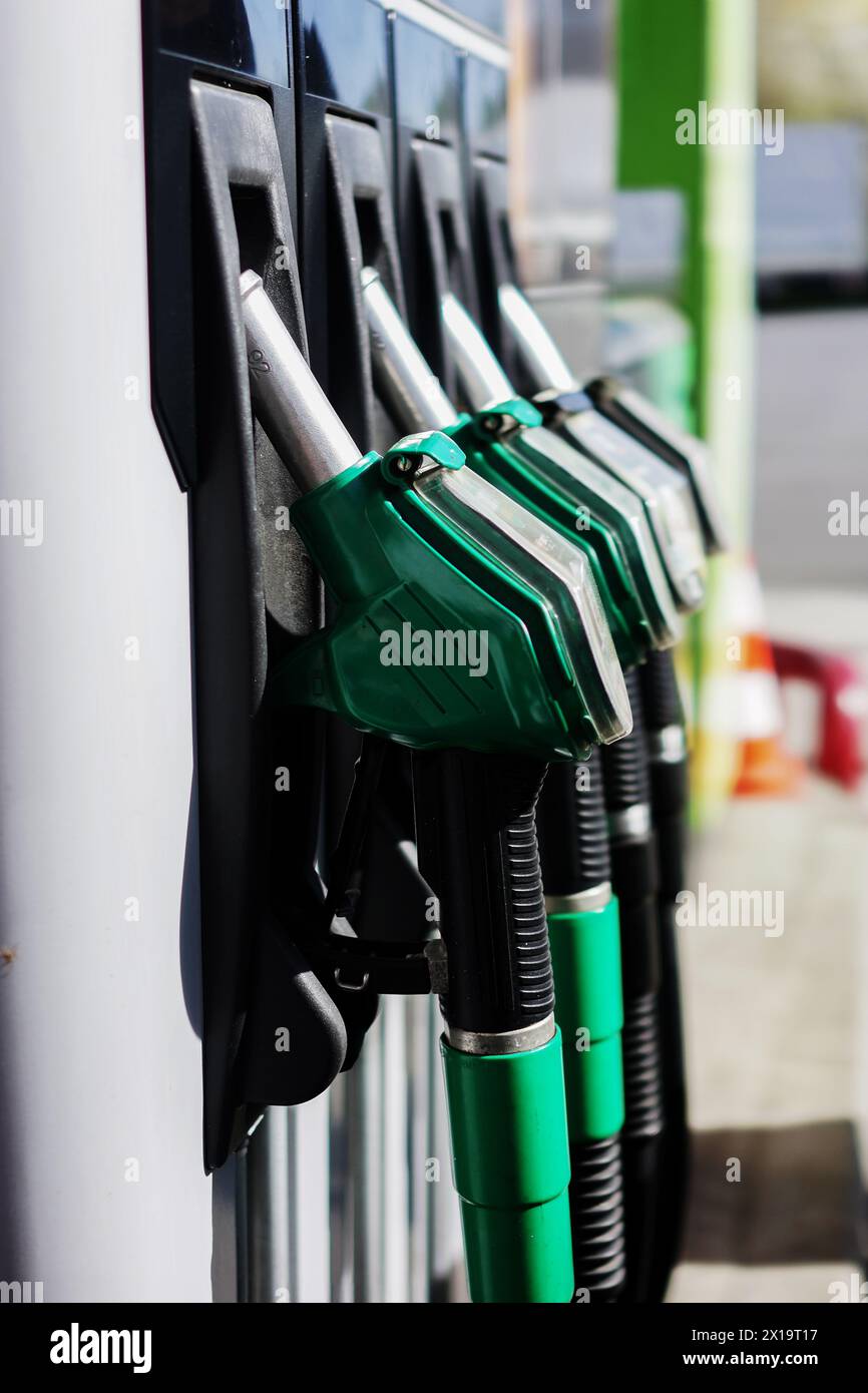 Close up of diesel and petrol fuel pistols at a gas station. The fuel ...