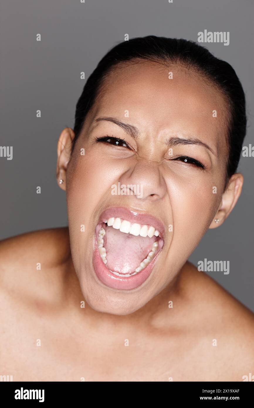 Portrait, woman and anger in studio for frustrated with scream, stress ...