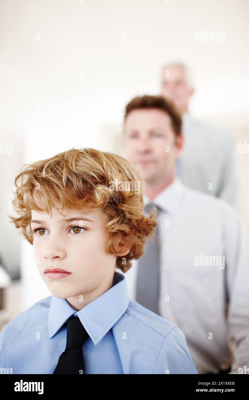 Boy, face and serious in home with family, bonding and generations ...