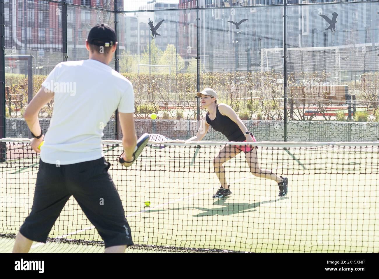 Portrait of two smiling sportsman's posing on padel court outdoor with ...