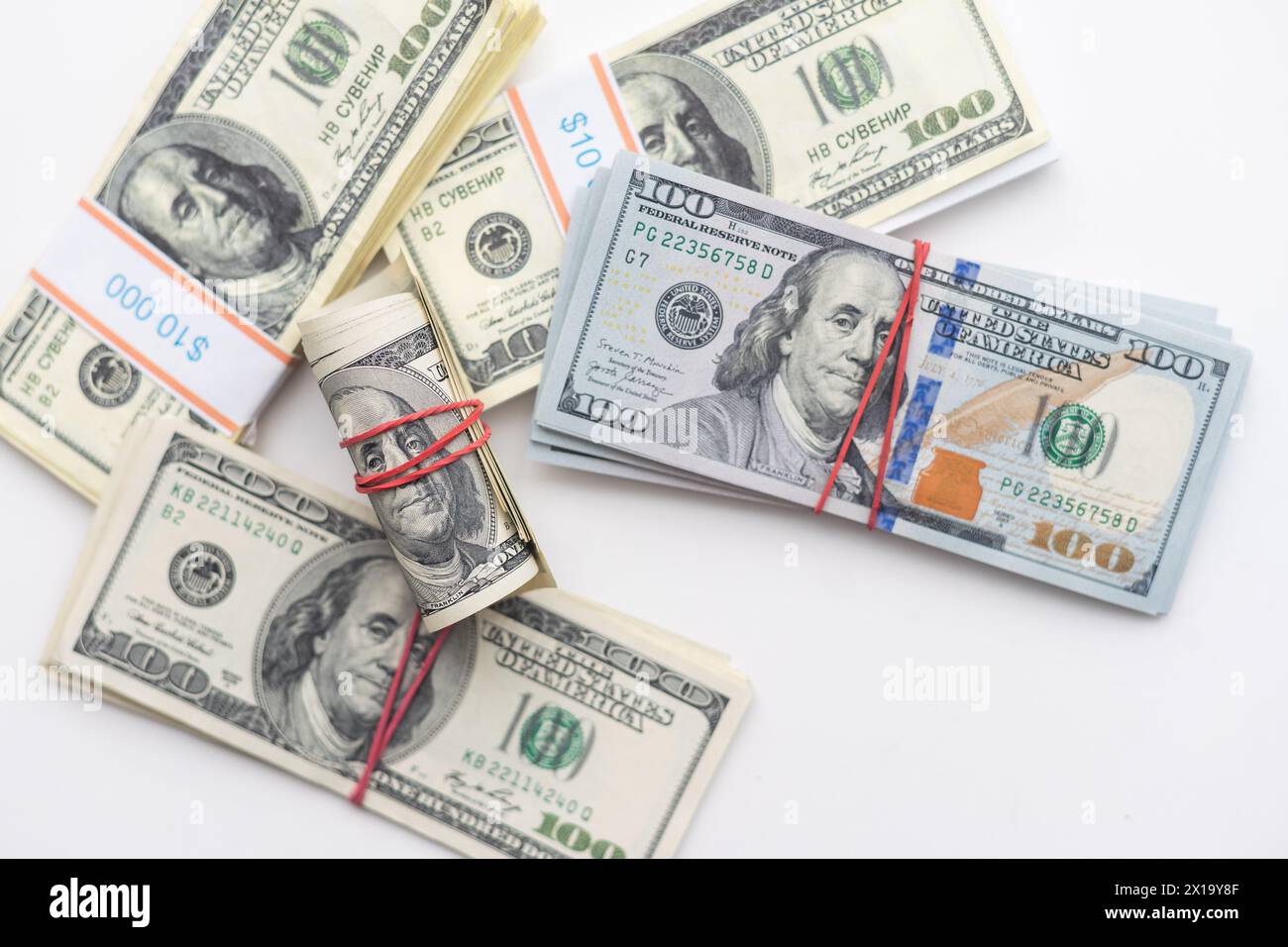 roles dollar notes in front of white background Stock Photo - Alamy